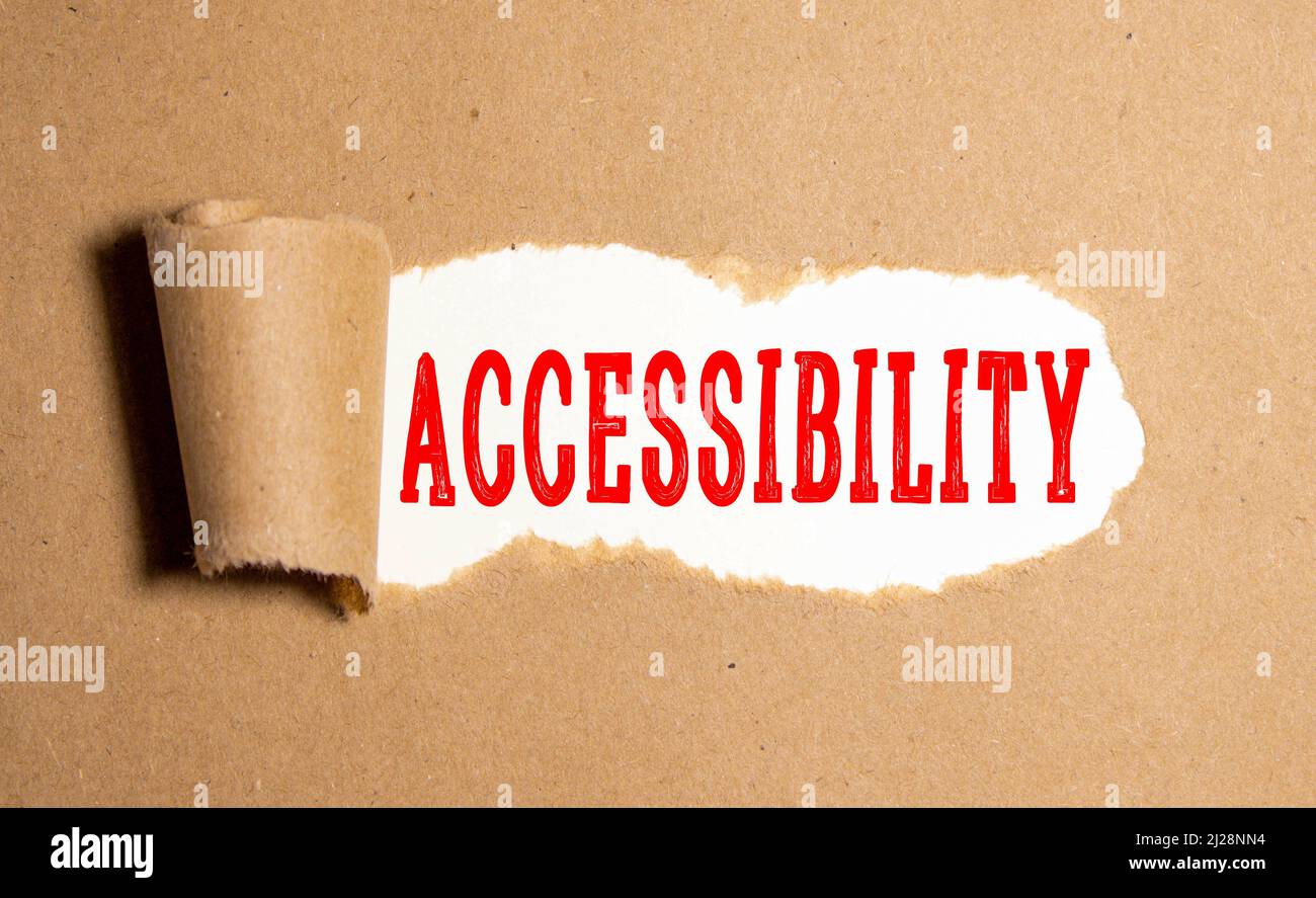 The word Accessibility appearing behind torn brown paper ...