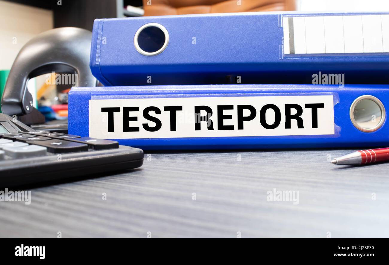 Test Report. Man carries stack of folders. File folders with text label ...