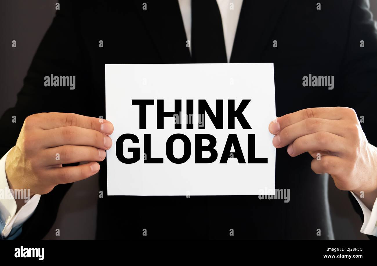 Think Global text on white paper, concept Stock Photo - Alamy