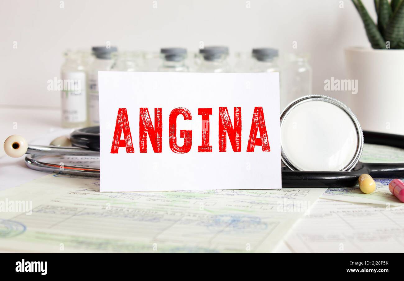 Angina word written on medical blue folder with patient files, pills ...