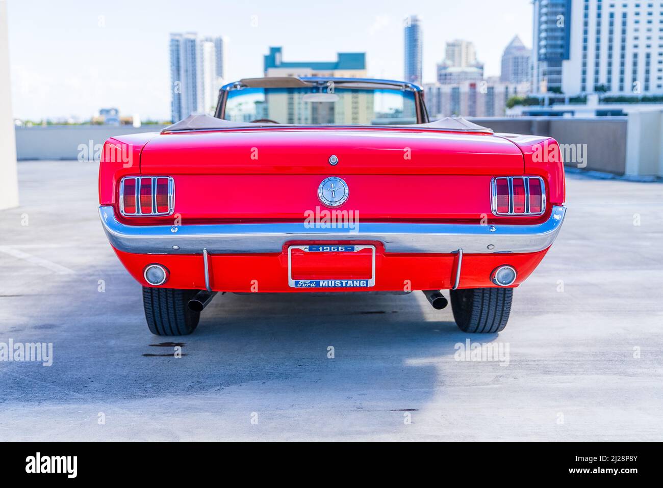 A back view of cool red 1966 convertible Ford Mustang with pony seats ...