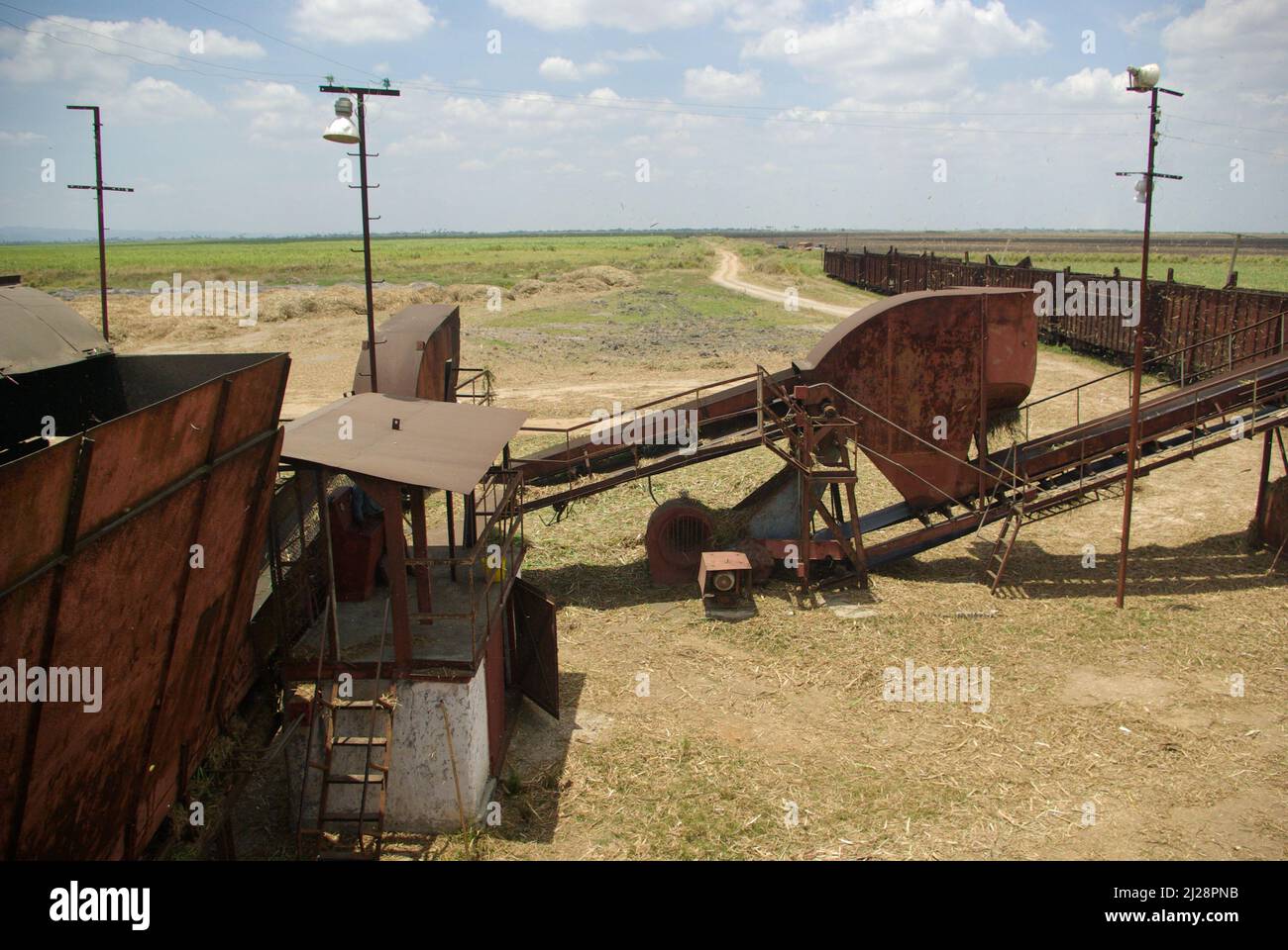 Chambas, Cuba, April 25, 2010. Loading sugar cane into train carriages ...