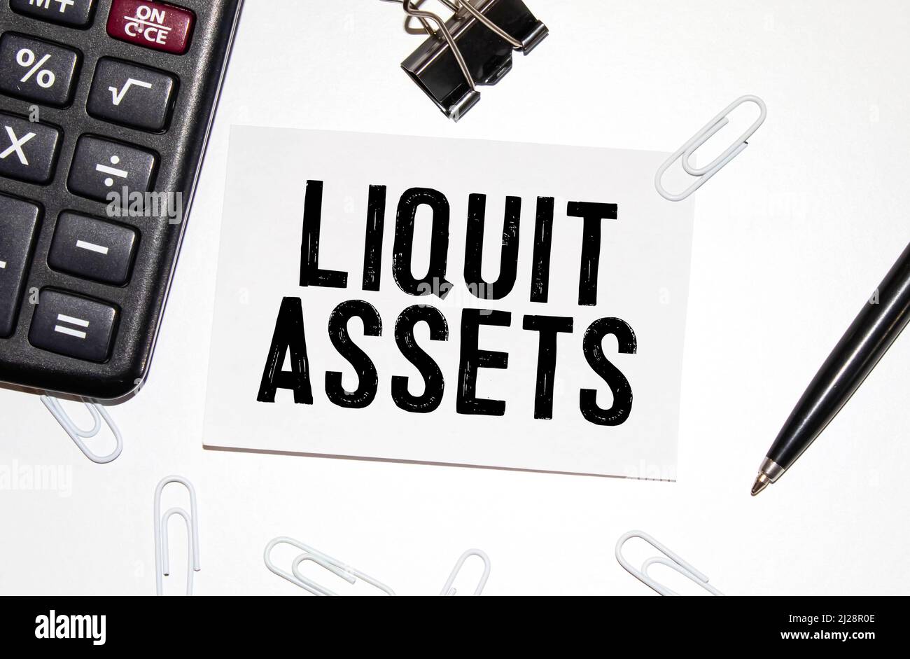 liquid assets. text on white paper on gray background near calculator ...