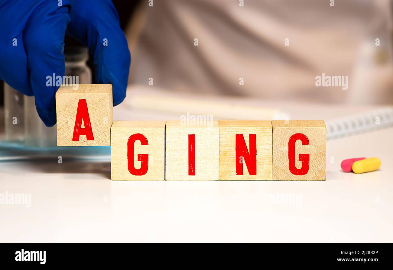 Aging - word from wooden blocks with letters, growing old senescence ...