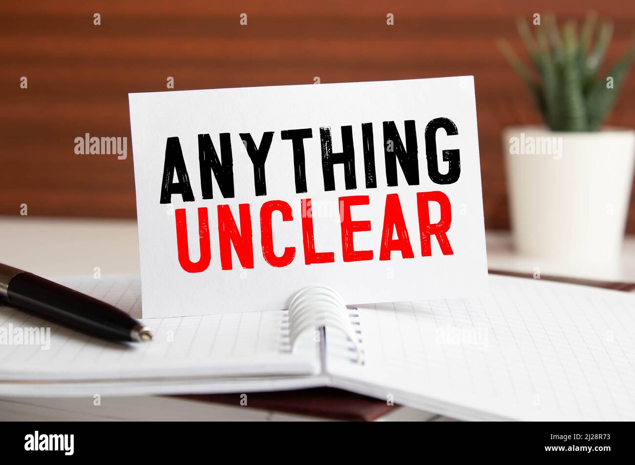 ANYTHING UNCLEAR text on paper sheet with chart, dice, spectacles, pen ...