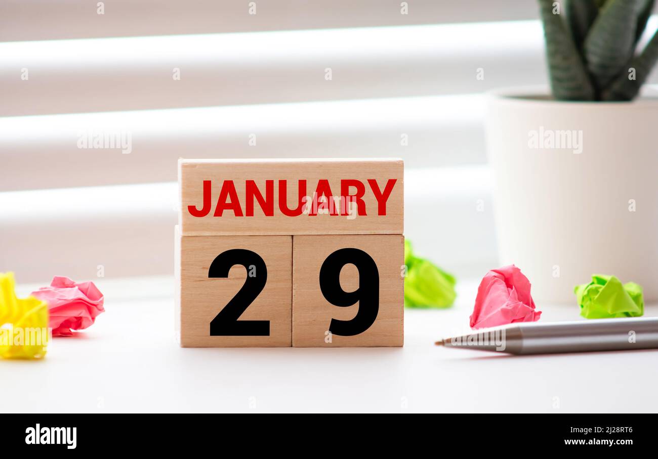 Cube shape calendar for January 29 on wooden surface with empty space ...