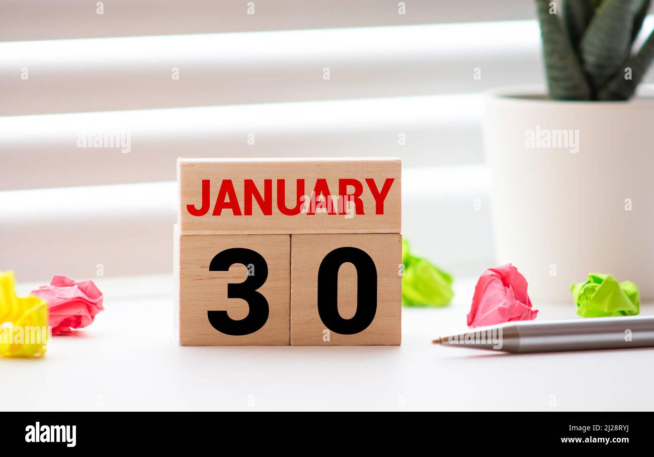 White block calendar present date 30 and month January on white wall ...