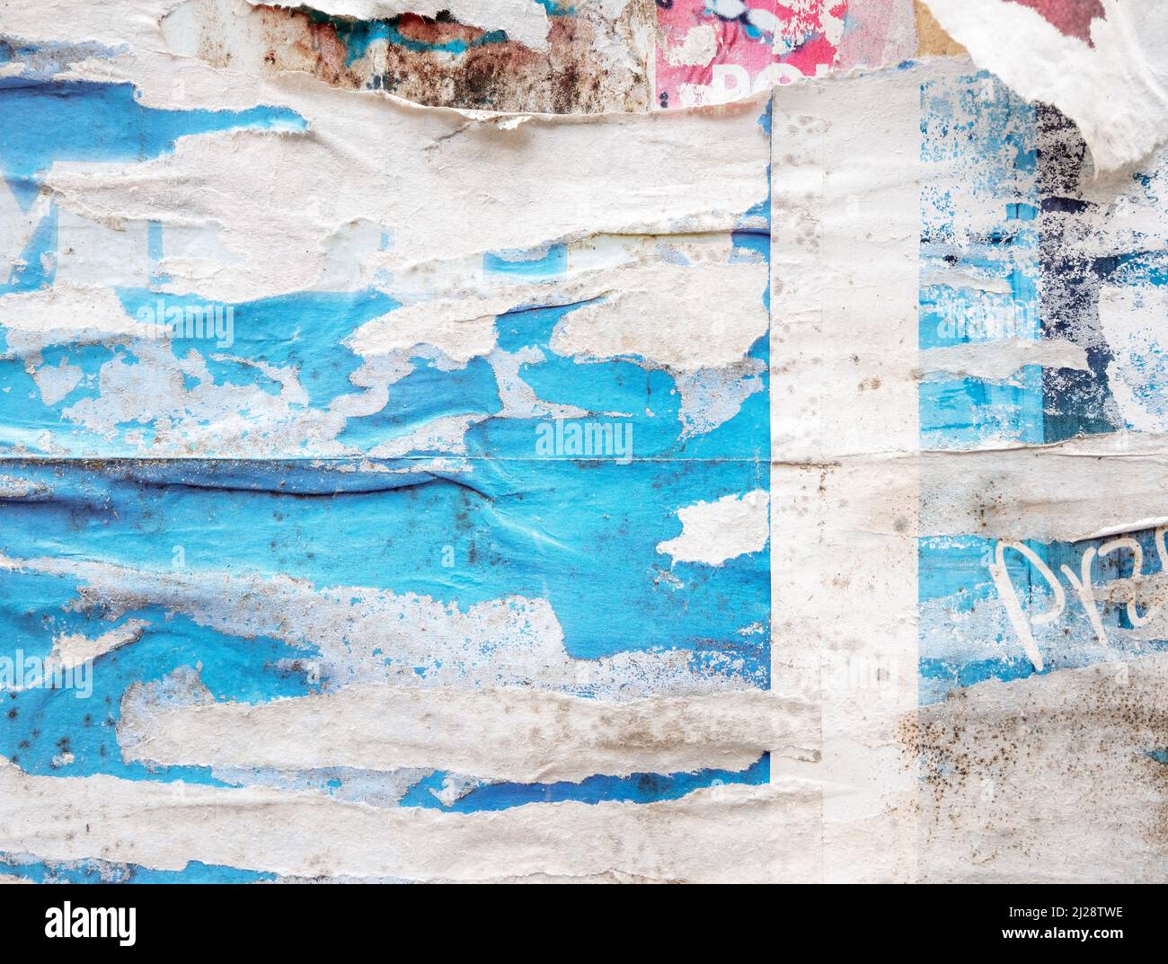 Lots of torn damaged paper posters, adverts, scraped off advertisements ...