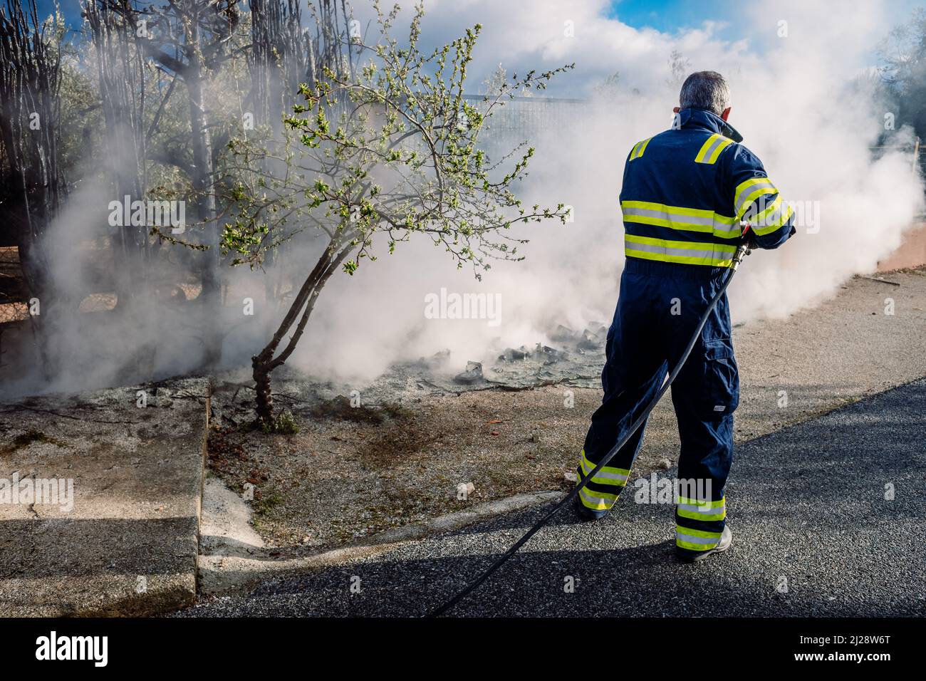 Scene of extinguishing a fire by a professional firefighter using a ...