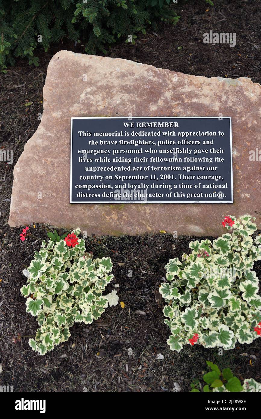 Streamwood, Illinois, USA. Plants and a boulder with a plaque form a ...