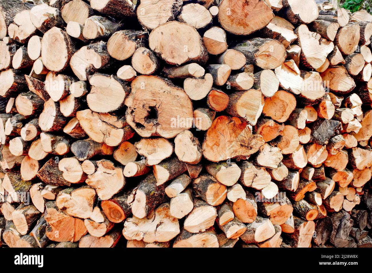 Pile of perfectly cut and stacked logs of wood to fuel the heating fire ...