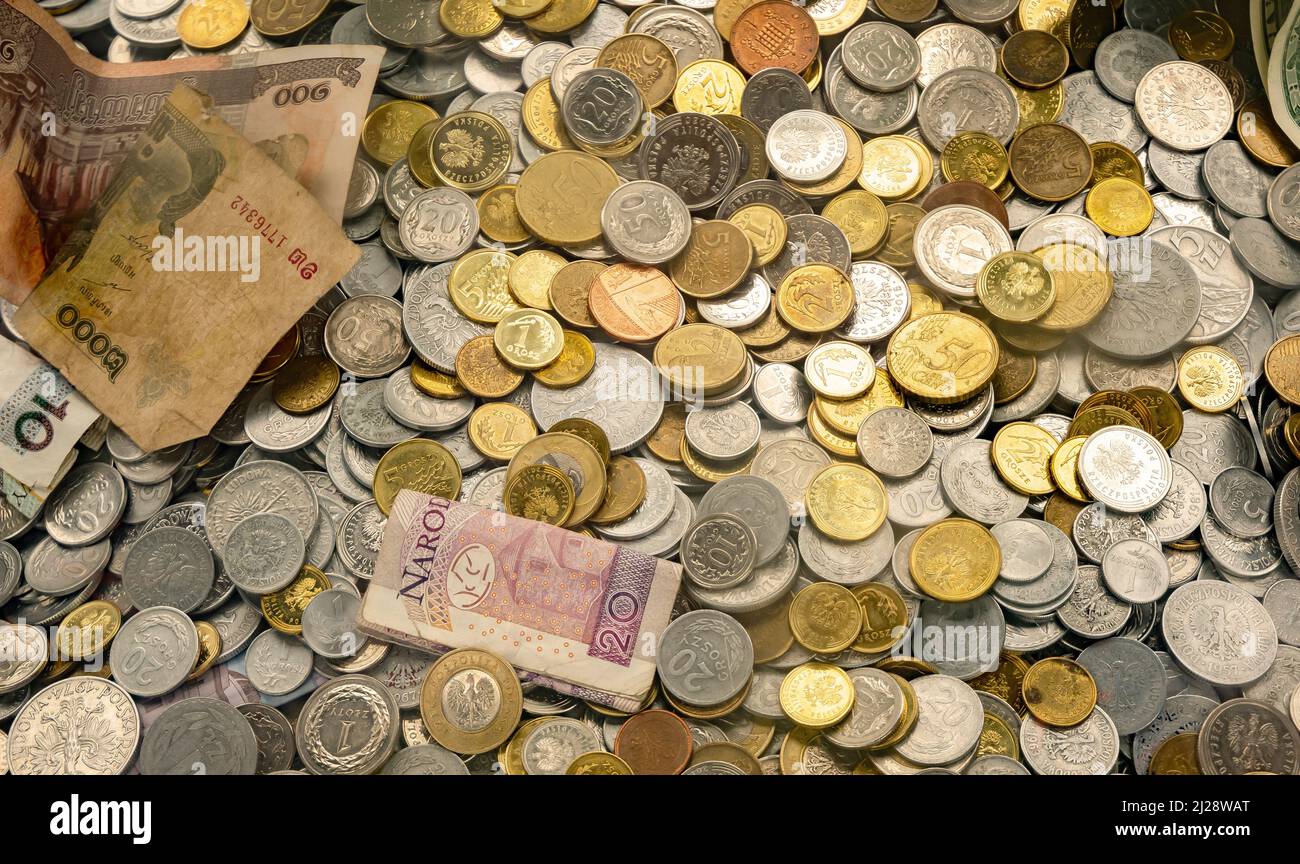 Lots of different coins, heap of money background, donation box inside ...