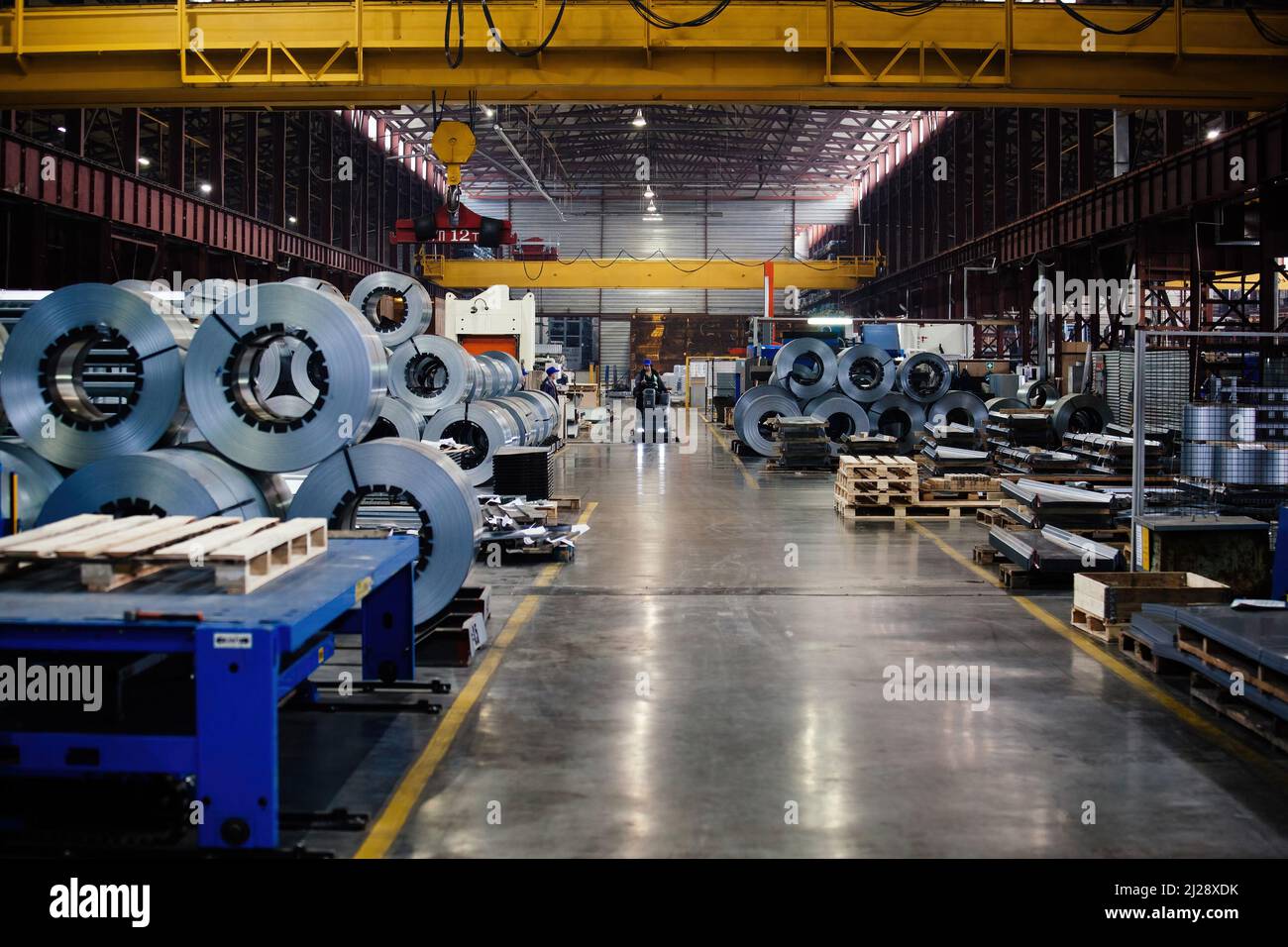 Metalworking factory production line. Rolls of steel and metal profiled ...