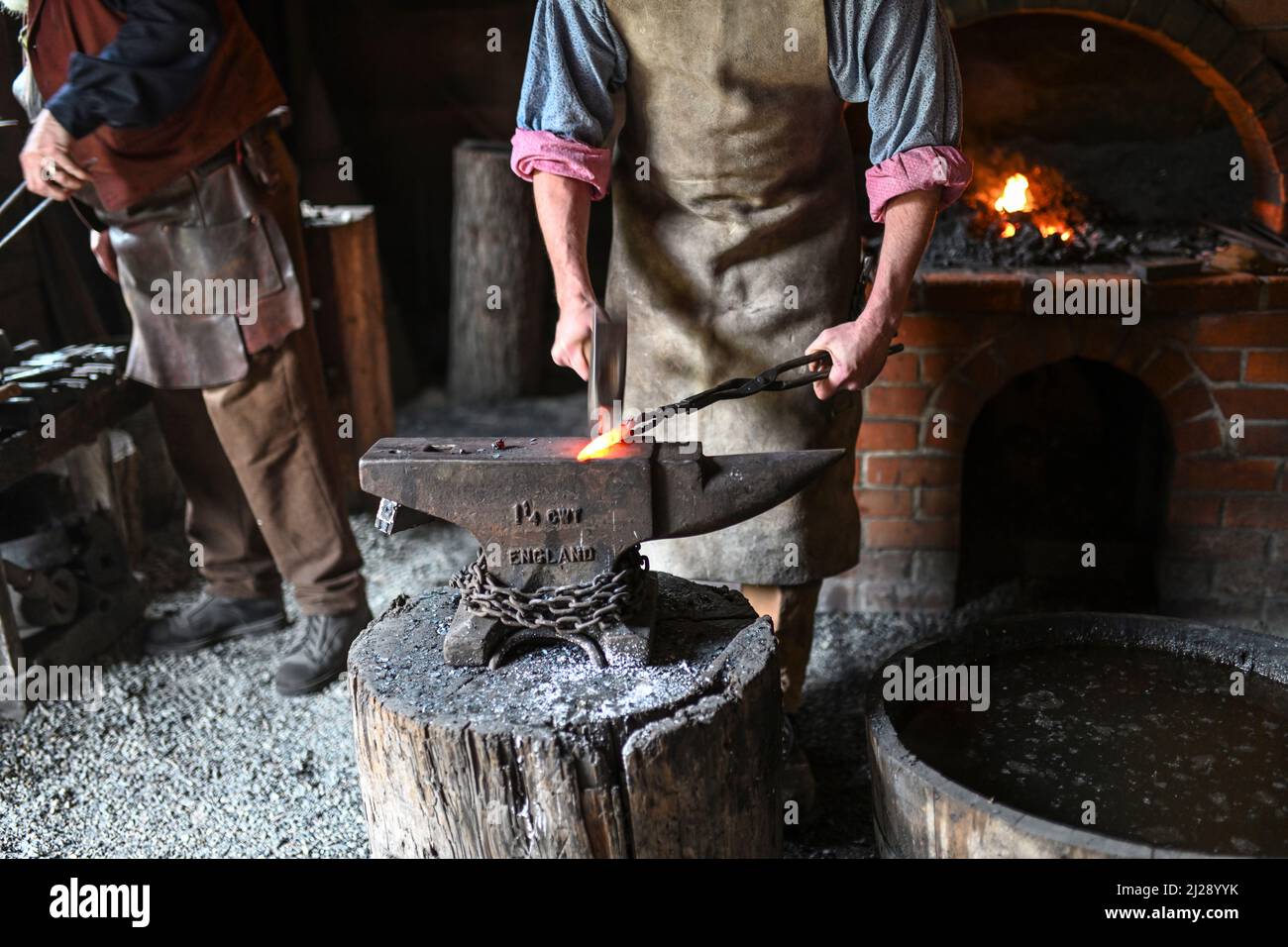 blacksmiths reenact making Christmas decorations by molding hot iron ...
