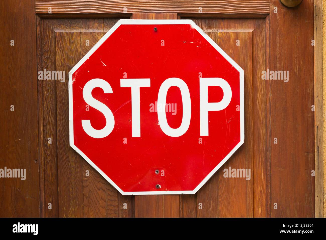 Traffic stop sign on wooden entrance door Stock Photo - Alamy
