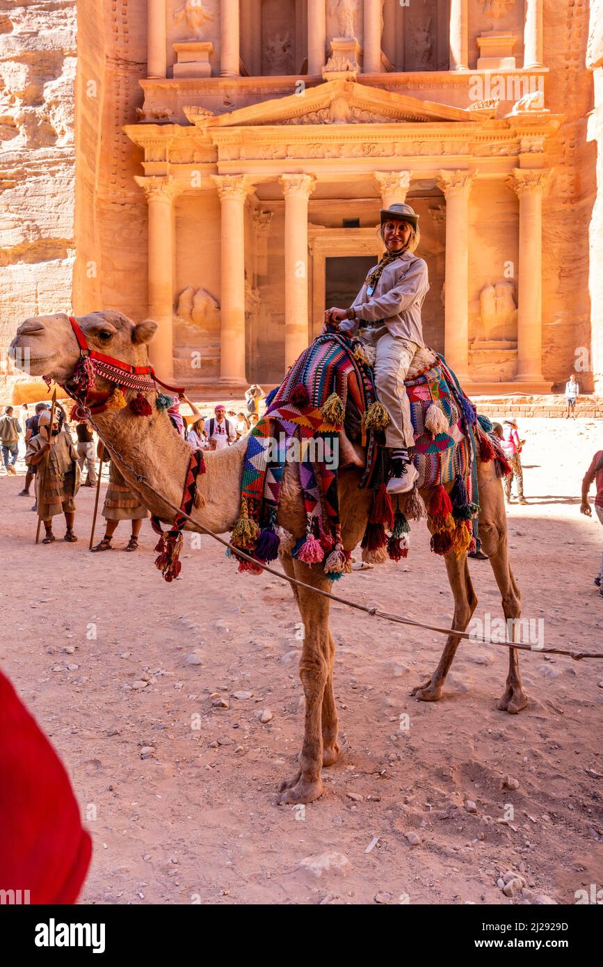 A Senior Woman Riding A Camel Outside The Treasury, Petra, Jordan Stock ...