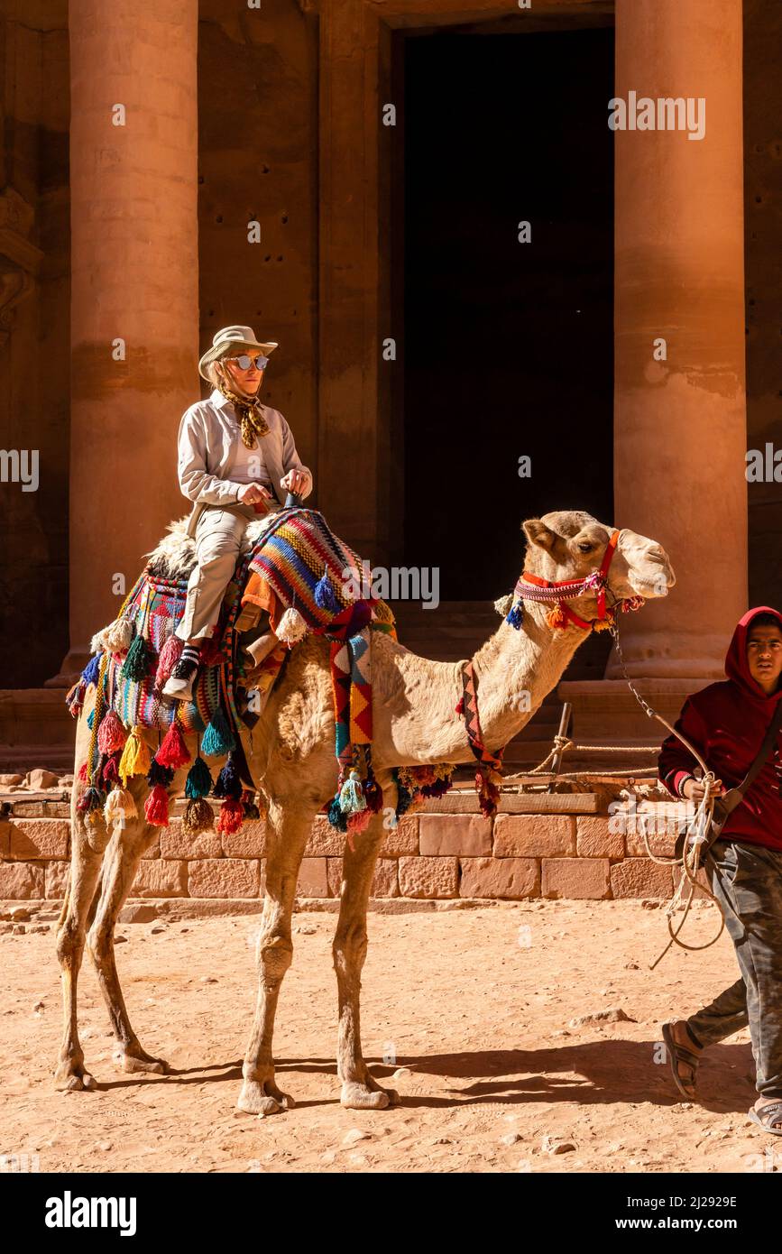 A Senior Woman Riding A Camel Outside The Treasury, Petra, Jordan Stock ...