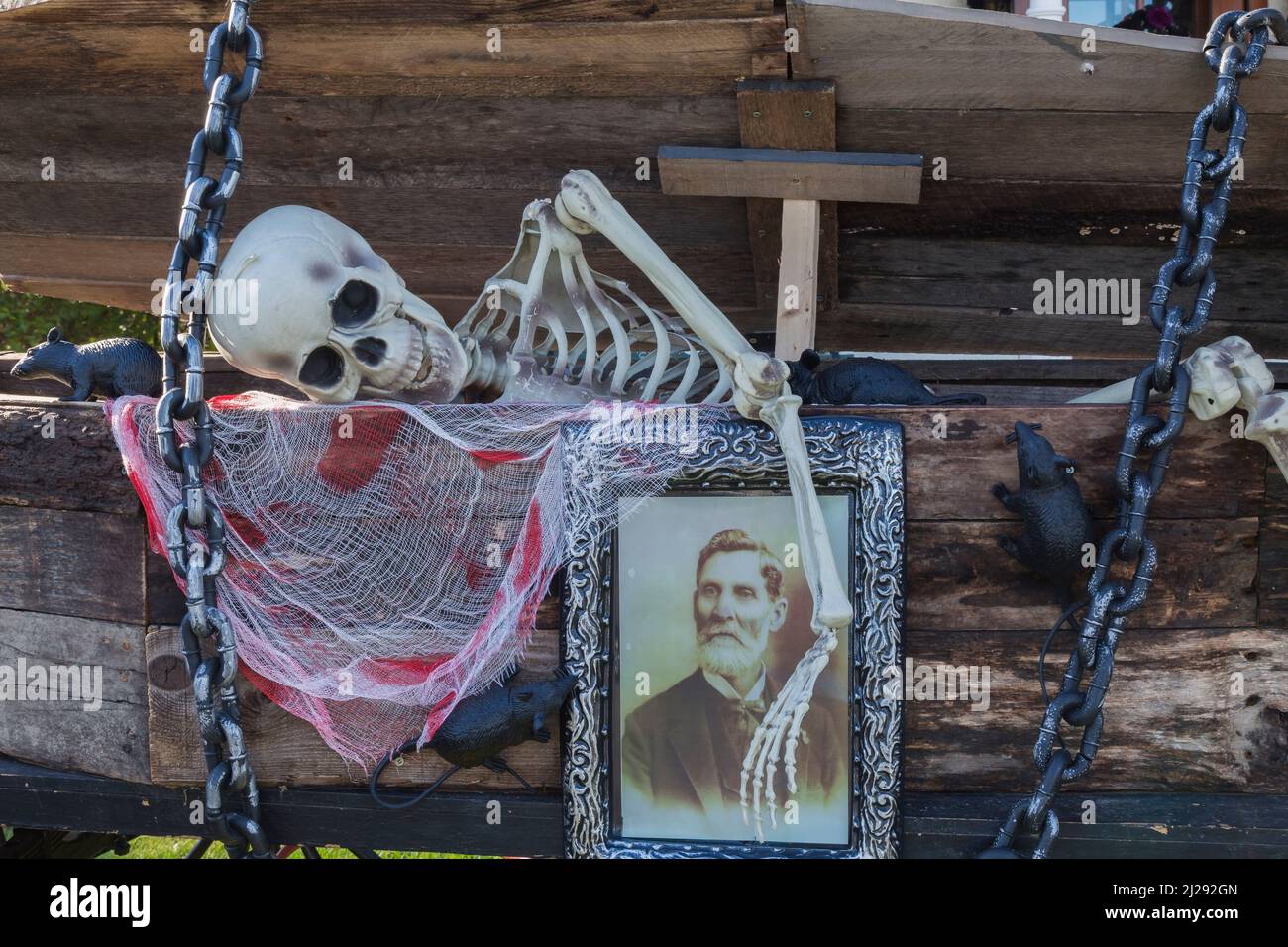 Opened wooden coffin decorated with framed holographic portrait and ...