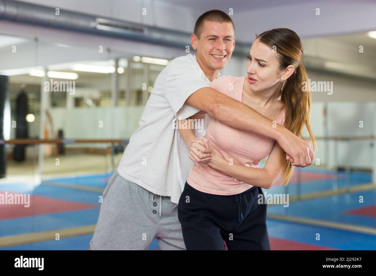 Young woman exercising elbow strike during self-protection training ...