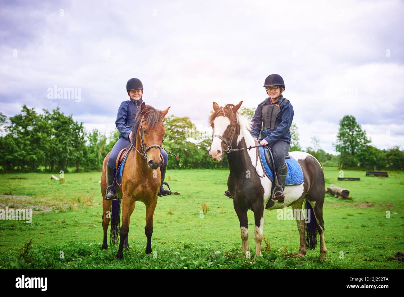 Saddle up, its time to ride. Shot of two teenage girls going horseback ...