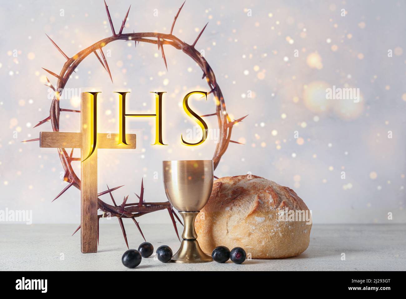 Chalice of wine with bread, cross and crown of thorns on light ...
