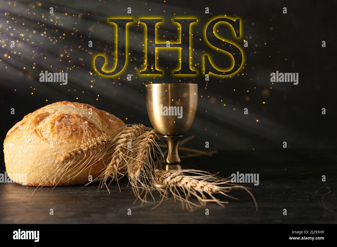 Chalice of wine with bread on dark background. Holy Communion concept ...