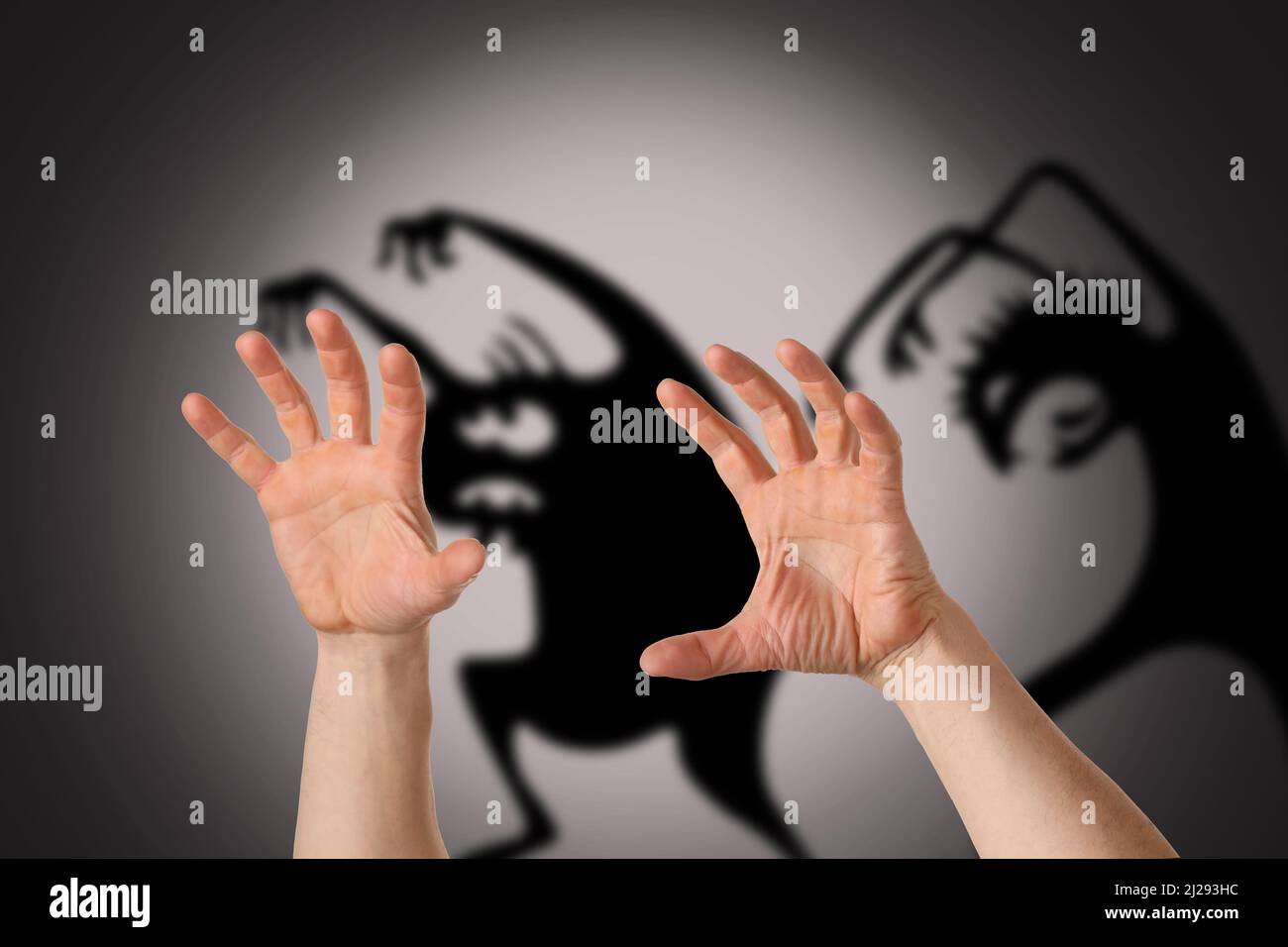 Hands of scared man and silhouettes of monsters on grey background ...