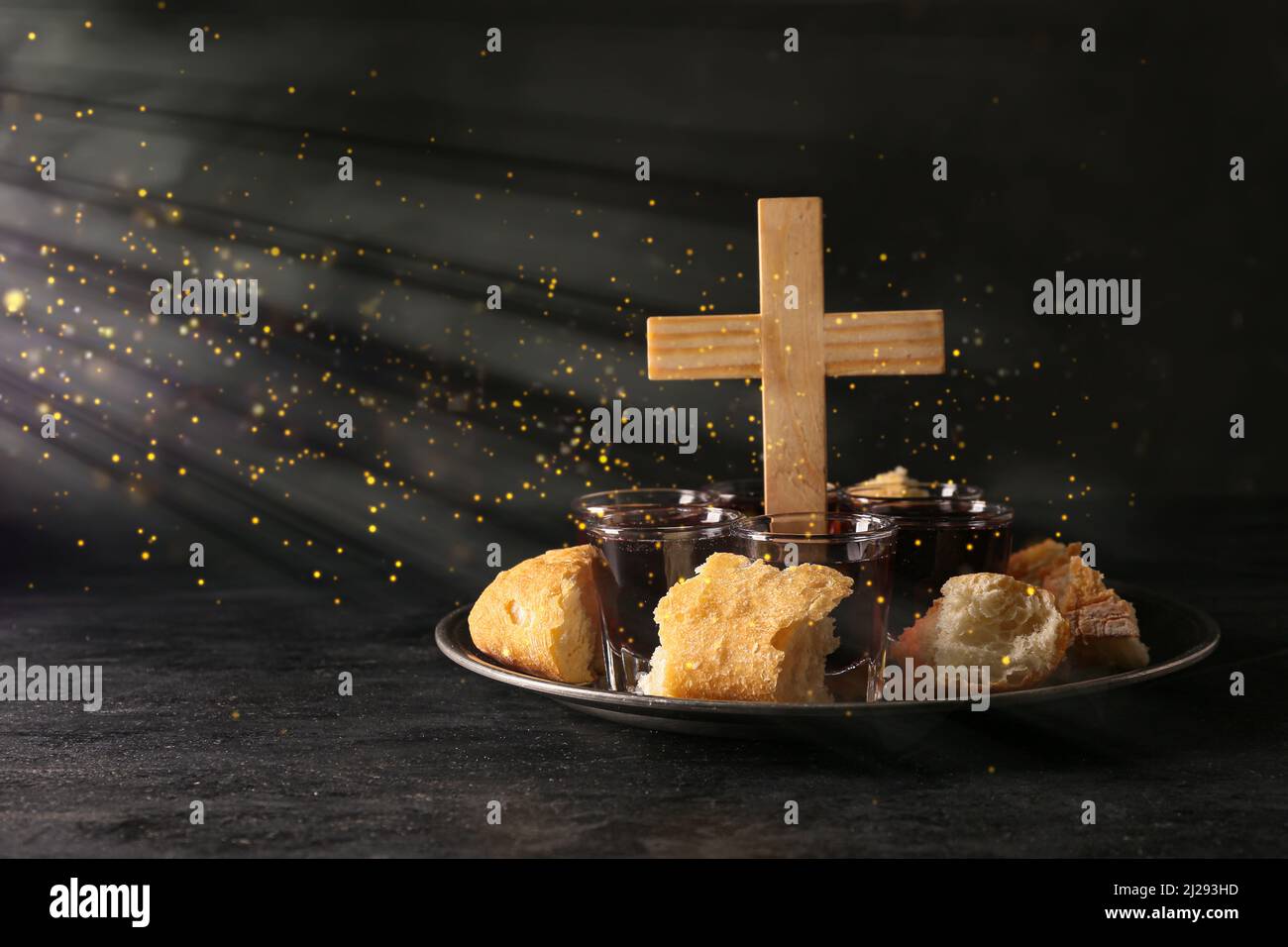 Tray with glasses of wine, bread and cross on dark background. Holy ...