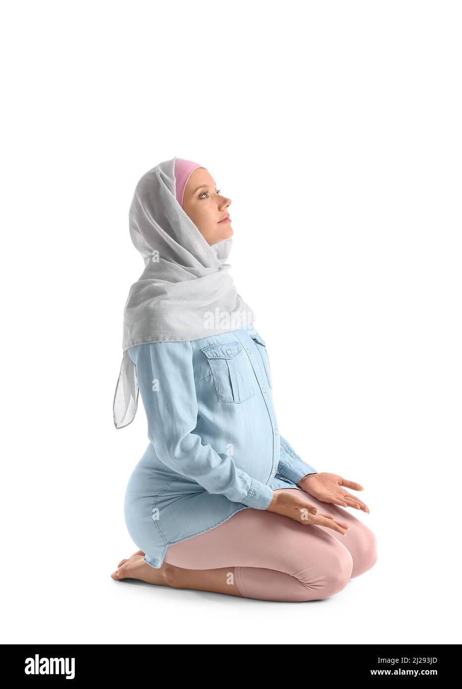 Pregnant Muslim woman meditating on white background Stock Photo - Alamy