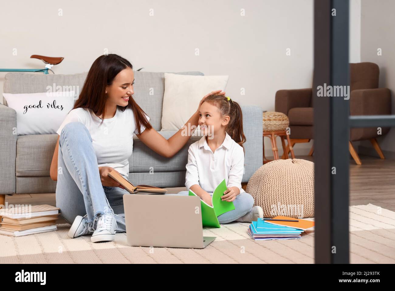 Cute girl studying with tutor at home Stock Photo - Alamy