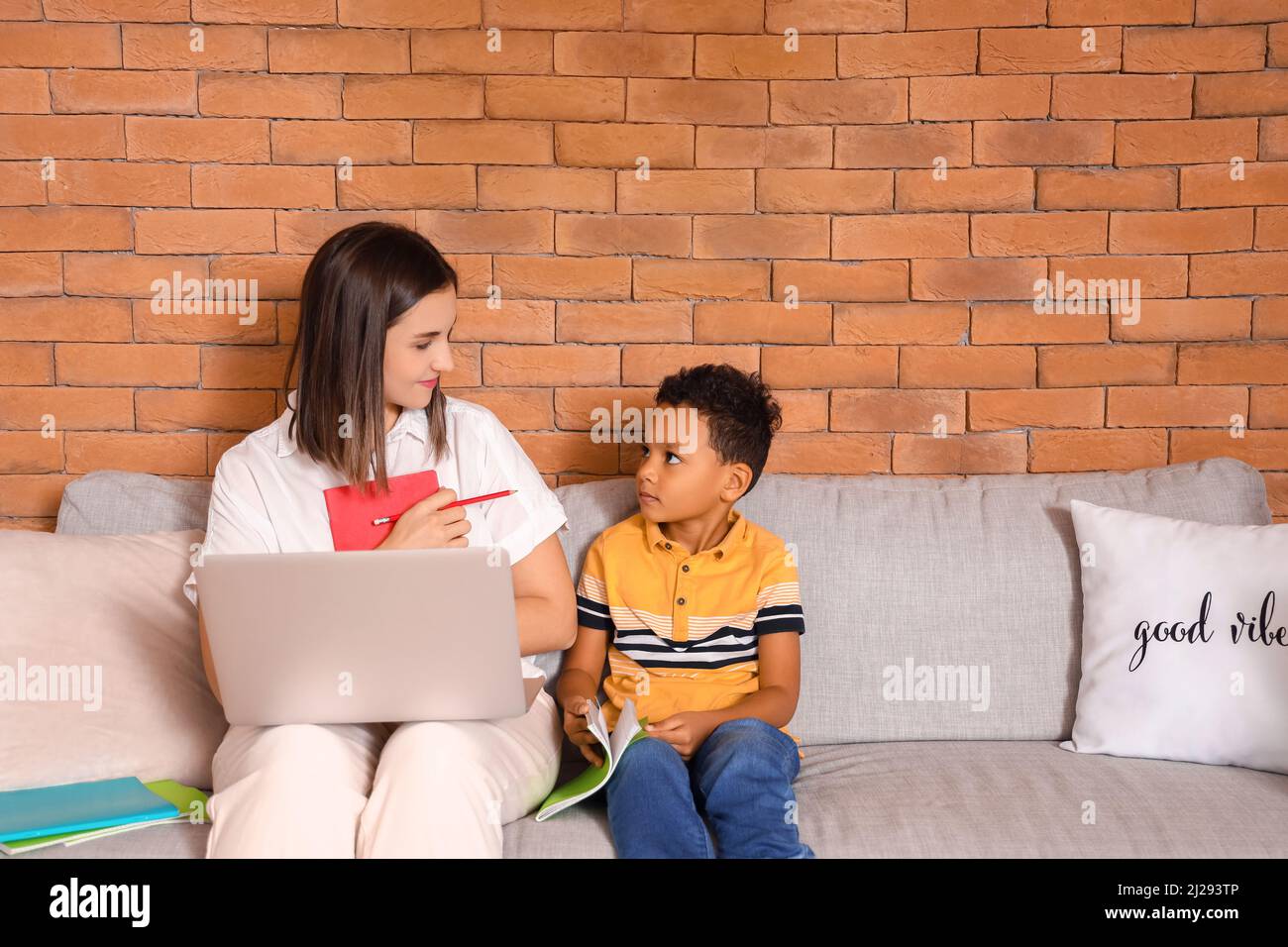 Little African-American boy studying with tutor at home Stock Photo - Alamy