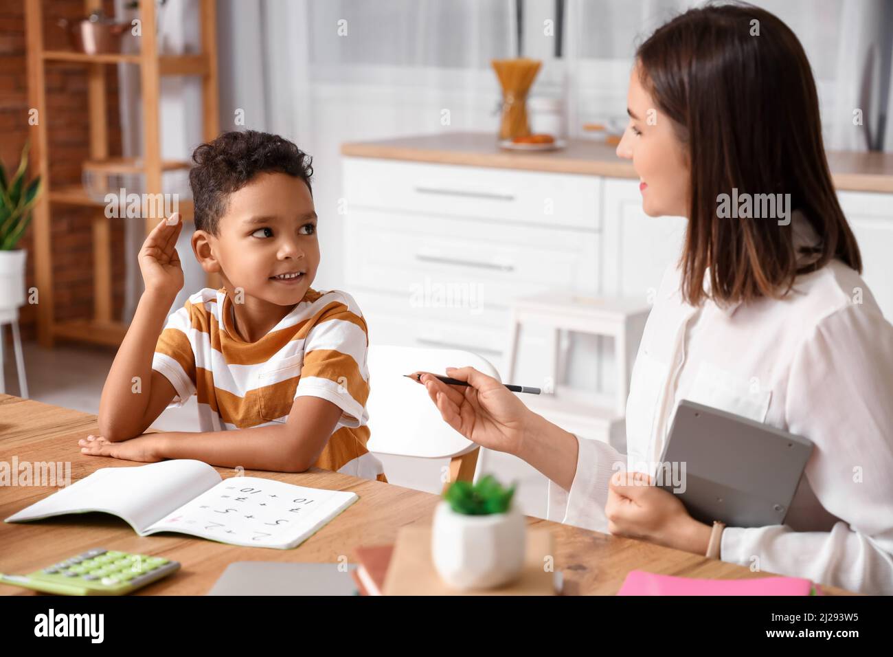 Little African-American boy asking his tutor question at home Stock ...