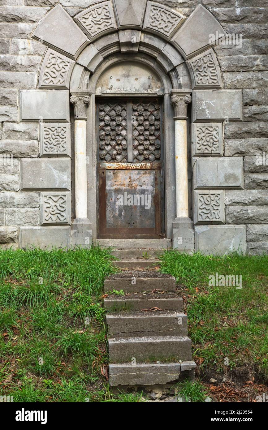 Mausoleum facade with medieval style black steel entrance door and ...