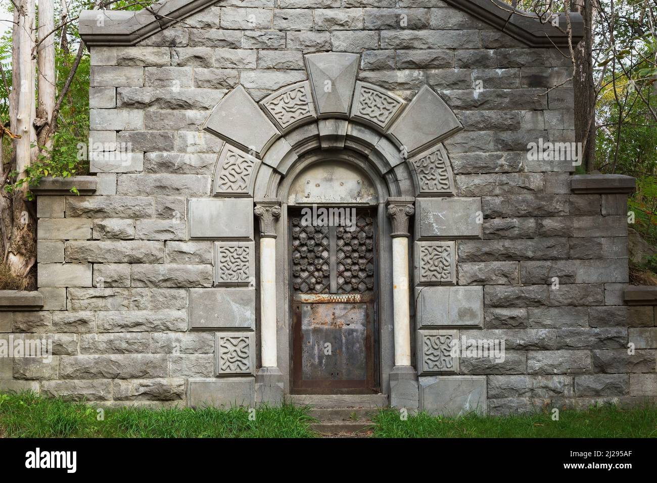 Mausoleum facade with medieval style black steel entrance door and ...