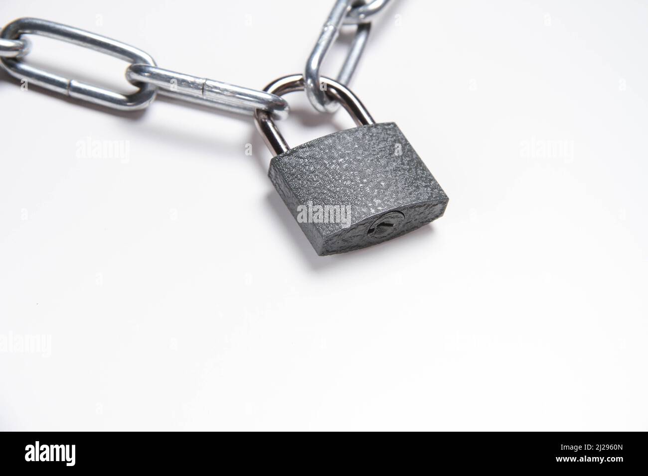 Chain and padlock on an isolated background. A locked padlock hangs on ...