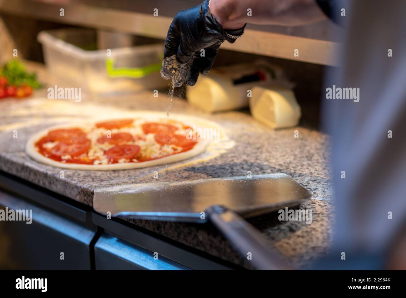 Italian chief-cooker baking pizza in the restaurant Stock Photo - Alamy