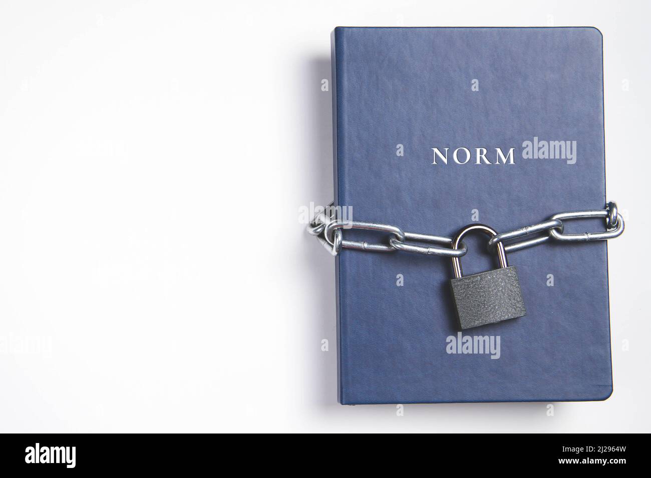 Norm. Book with lock. A closed book is banned. Chain on the book. On a ...