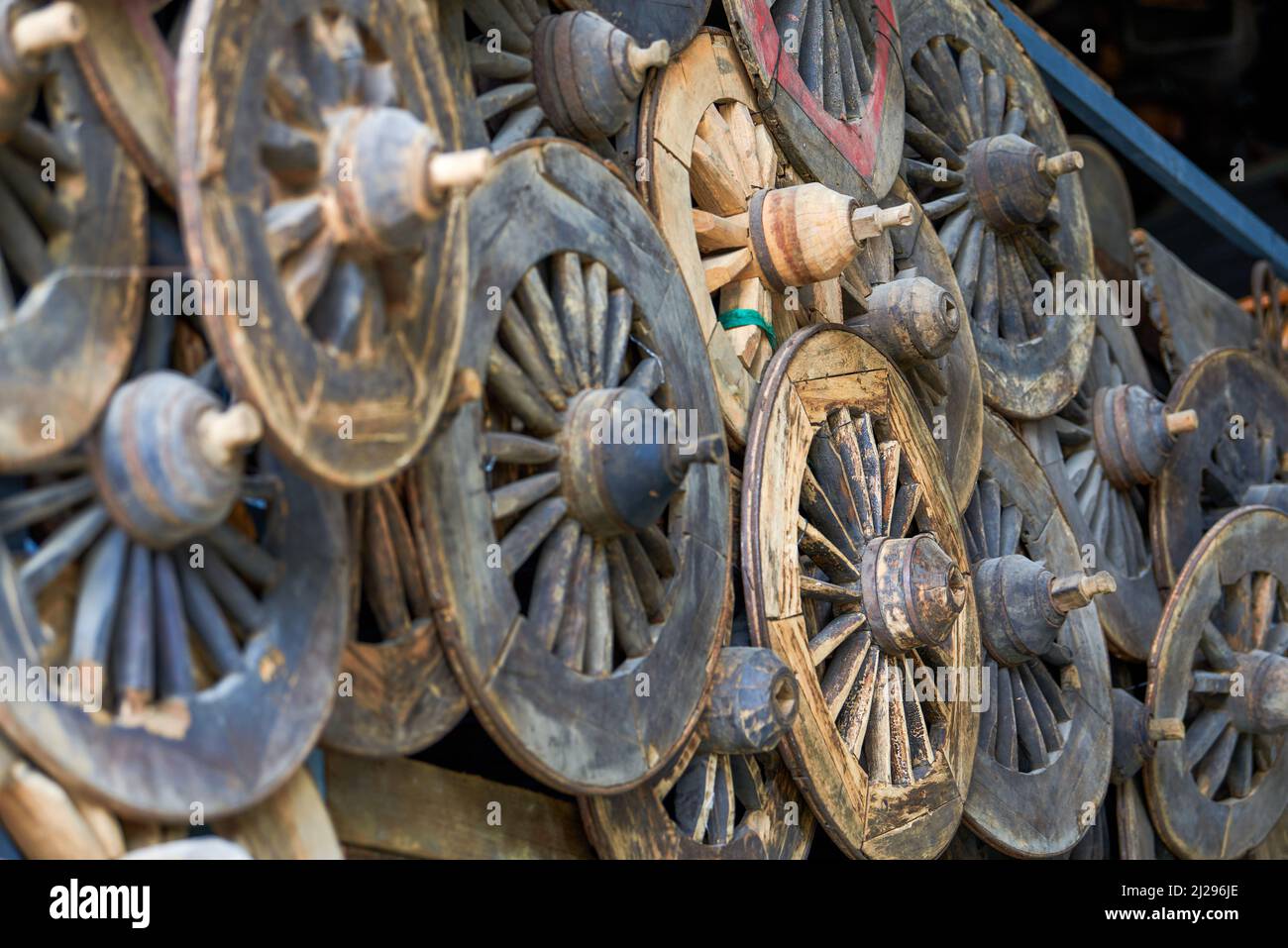 Traditional vintage wooden wheels hanging on the facade wall Stock ...