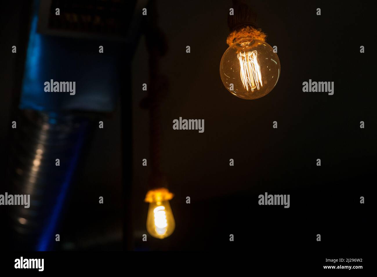 Picture of lightbulbs hnging from the roof, lighting and shining with a ...