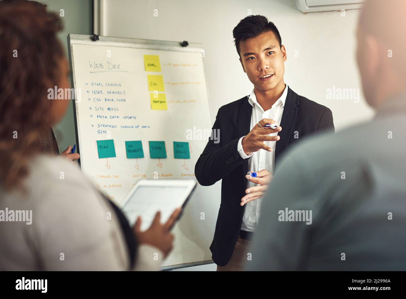 Fielding questions from his team. Shot of a young man giving a ...