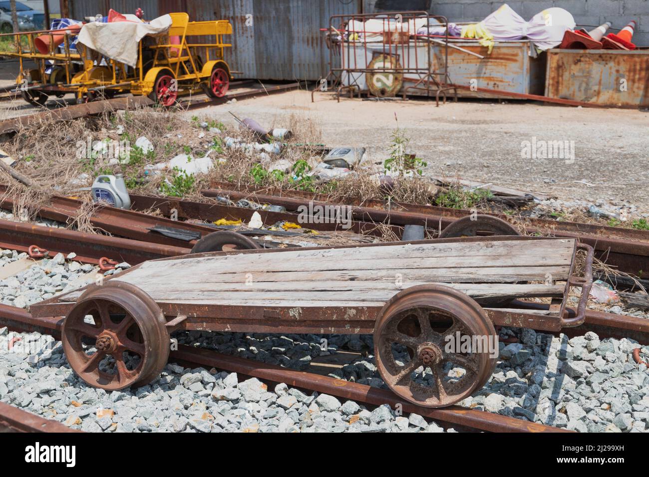 An old railroad cart with rusty wheels and broken wooden planks on an ...