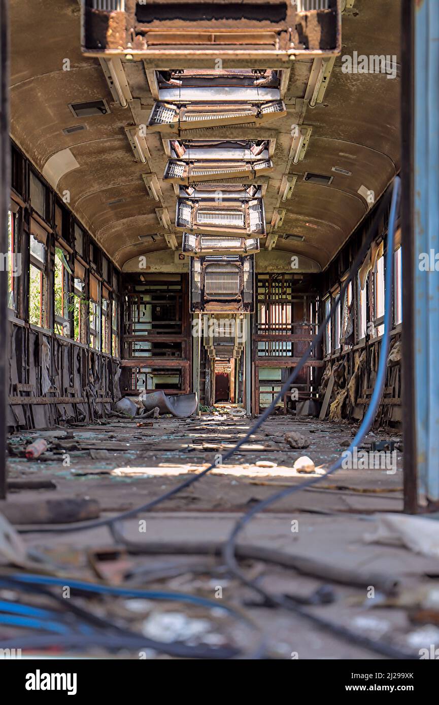 A vertical shot of the interior of an old, wrecked train wagon with ...