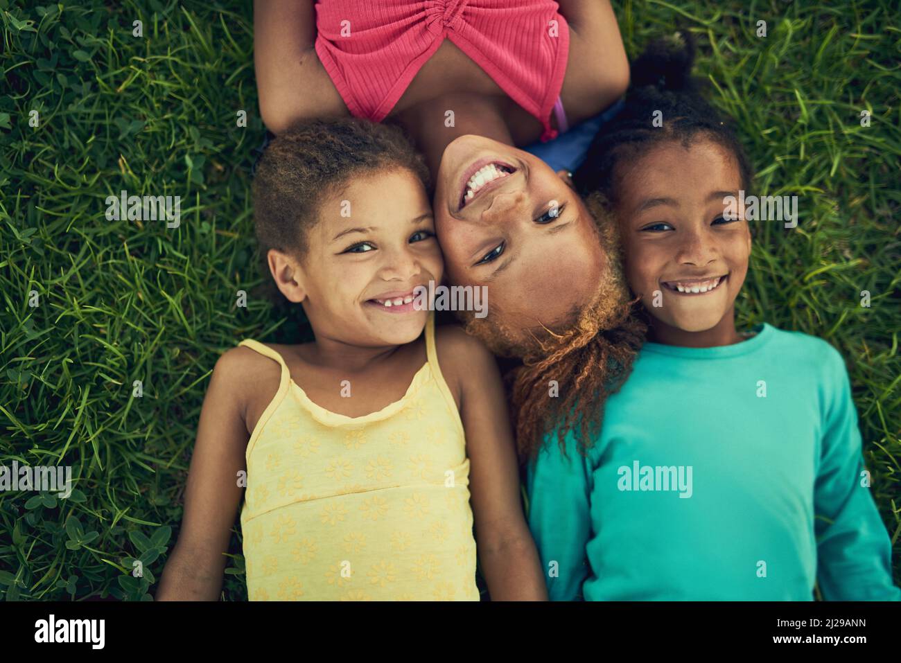 Fresh air and fun. High angle portrait of three little girls lying on ...