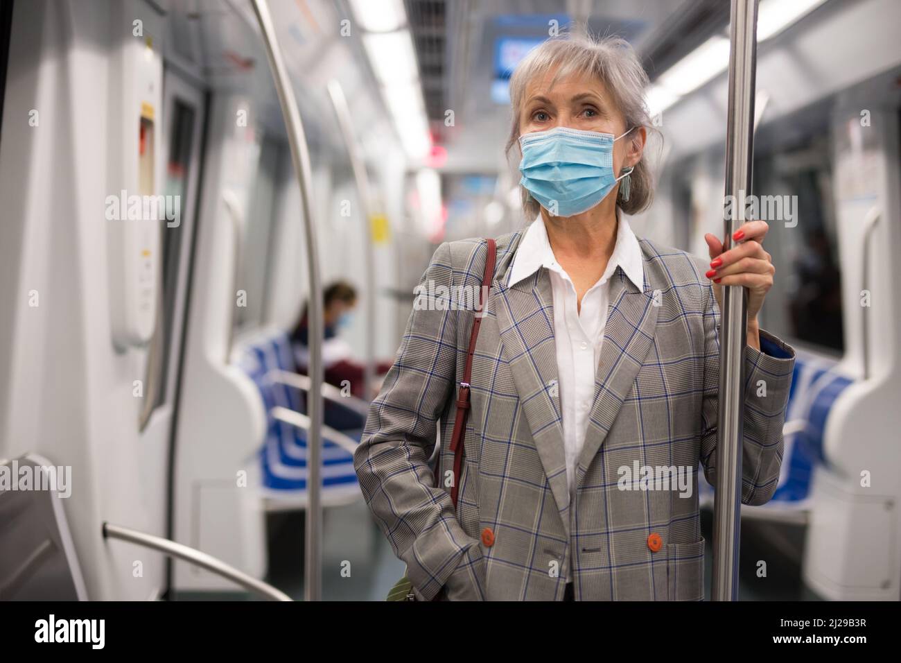 Senior lady standing transport hi-res stock photography and images - Alamy