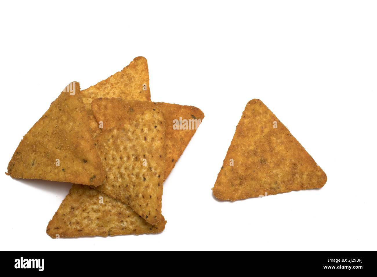 Close up of stack of triangular golden brown crispy fried tortilla ...