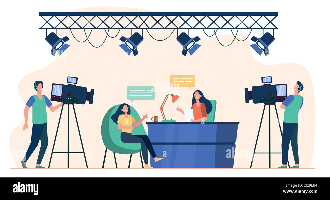 Videographers shooting interview in TV studio. News host talking to TV ...