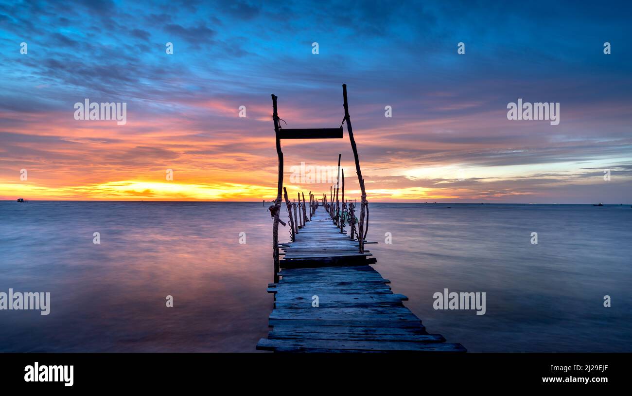 Wooden bridge on the beach at dawn in Phu Quoc island, Vietnam. Long ...