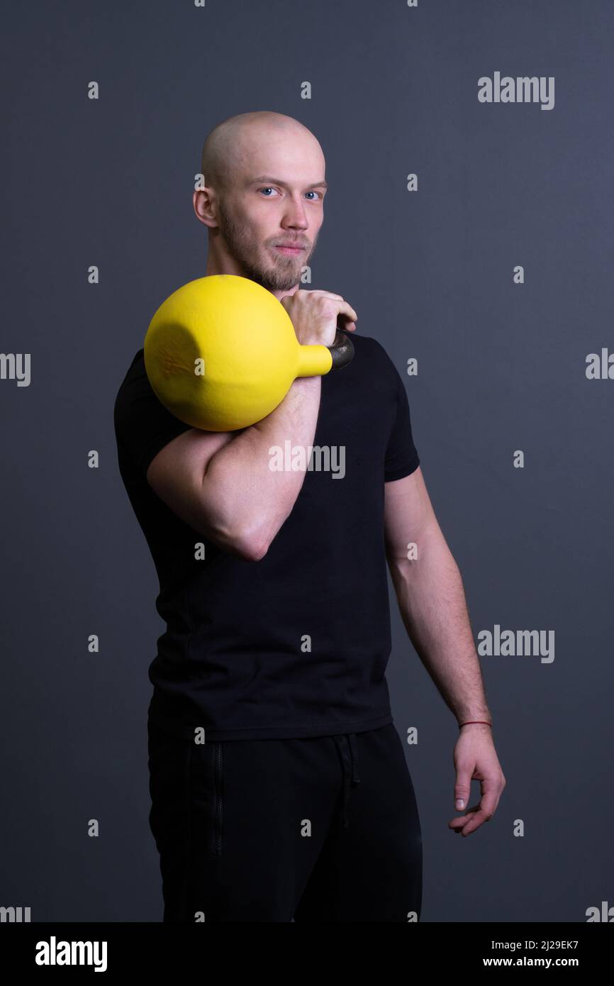 Guy with a yellow kettlebell gym anonymous yellow male, in the ...