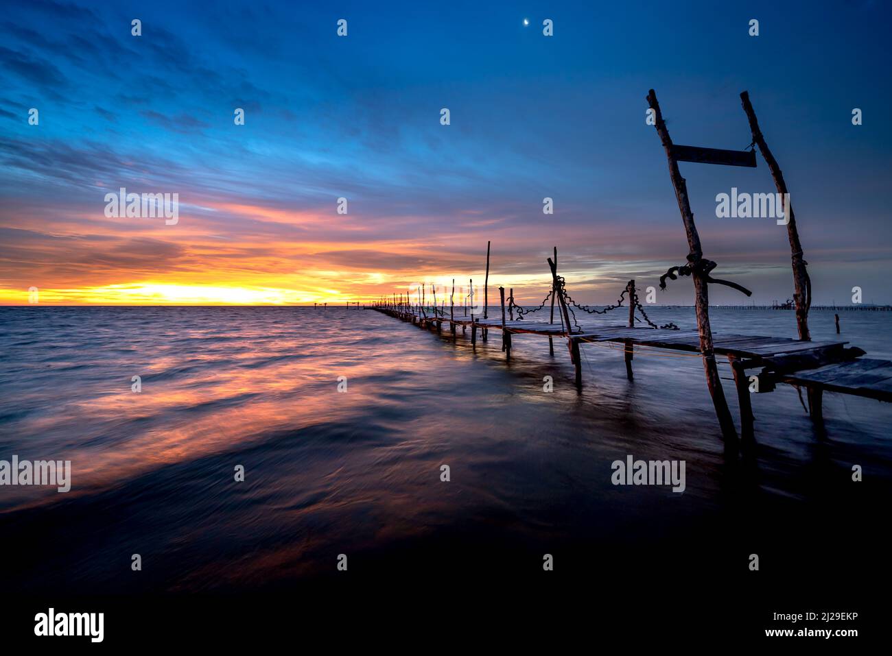 Wooden bridge on the beach at dawn in Phu Quoc island, Vietnam. Long ...