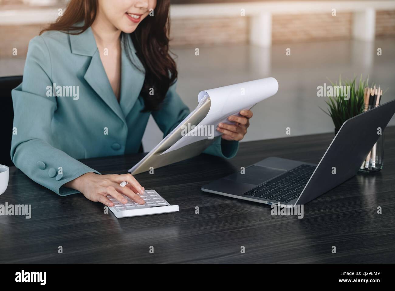 Financial and investment auditing concept, female auditor is pressing ...